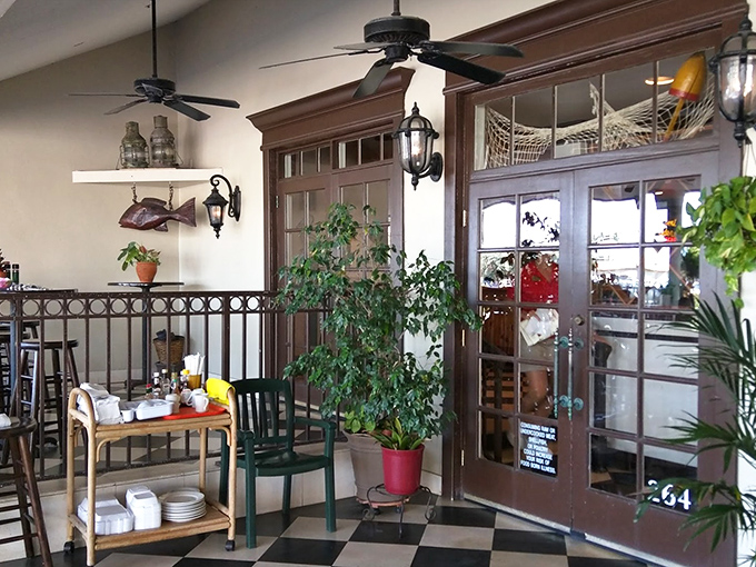 Plants stand guard at the entrance to flavor town. This little corner of paradise comes with ceiling fans and the promise of deliciousness.