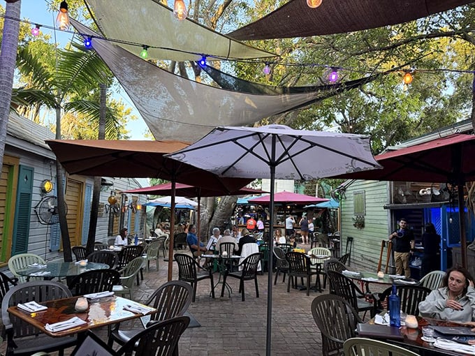 Outdoor dining under the shade sails feels like a bohemian block party where everyone's invited and the dress code is "happiness."