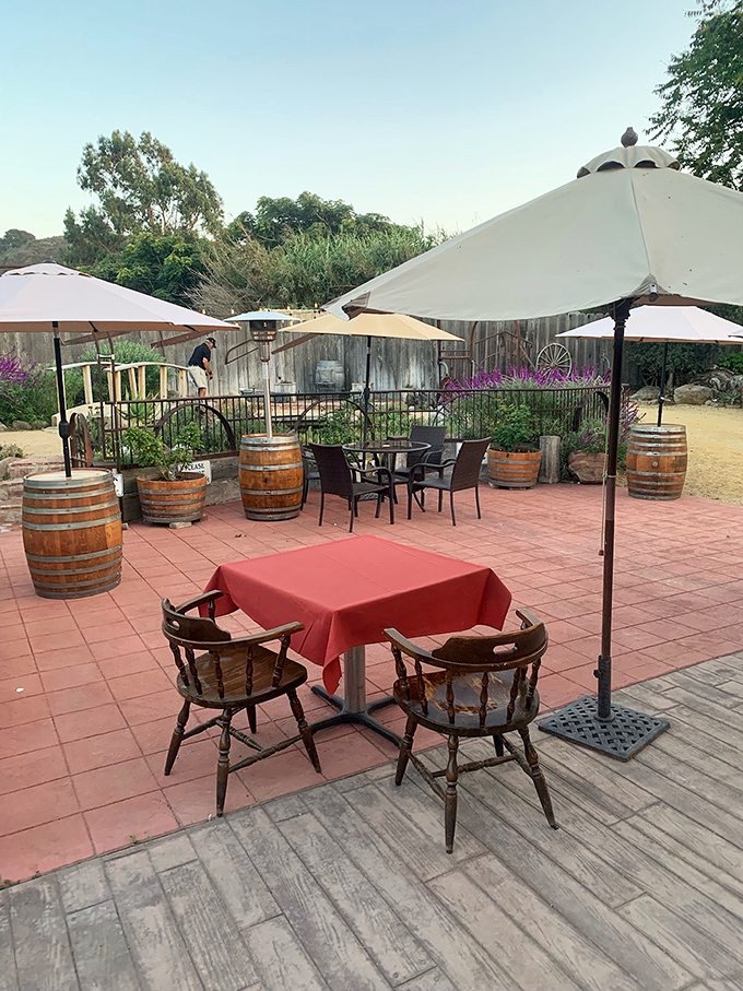 Even the outdoor seating carries the rustic charm&mdash;wine barrels and red tablecloths under umbrellas create an al fresco steakhouse experience.