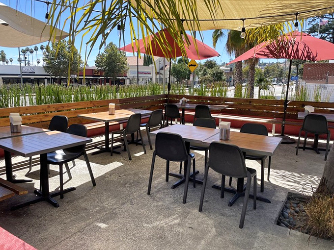 The outdoor patio offers California sunshine with your sandwich, where palm fronds wave gently as if applauding your menu choice.