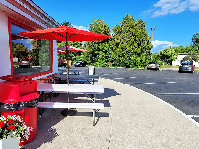 Outdoor seating where summer memories are made. Red umbrellas provide shade while you contemplate whether there's room for that second sundae.