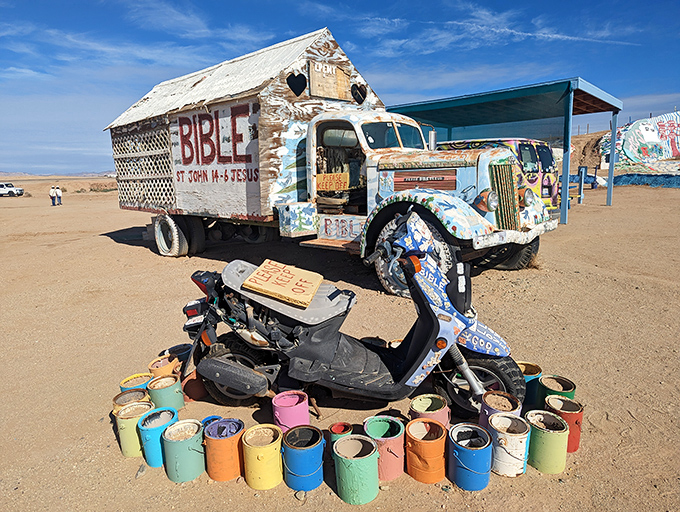 The circle of creativity continues. Paint cans surround a decorated scooter, tools of transformation waiting for the next splash of color.