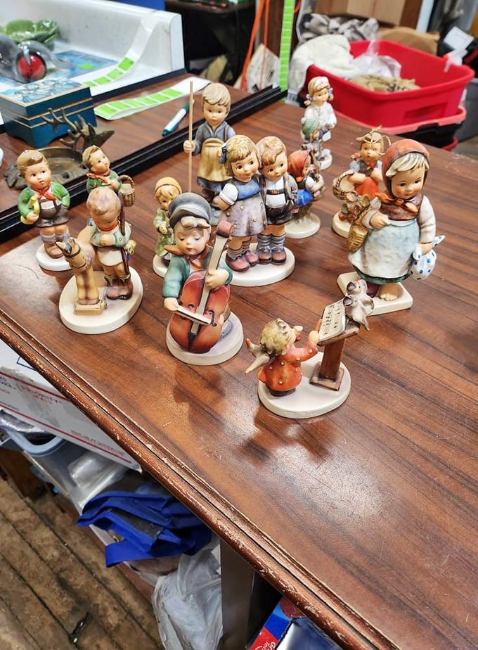 A choir of Hummel-style figurines stands at attention. Each porcelain child tells a story of craftsmanship that's increasingly rare in today's mass-produced world. 