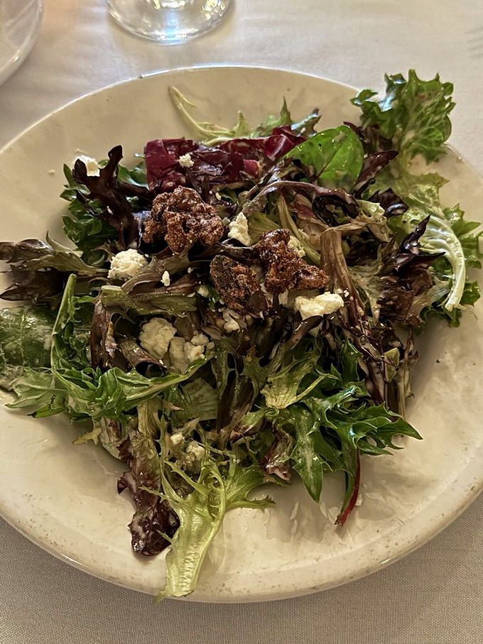 A salad that knows its role—bringing freshness and crunch while secretly thinking, "Just wait until you meet the steak that follows me."