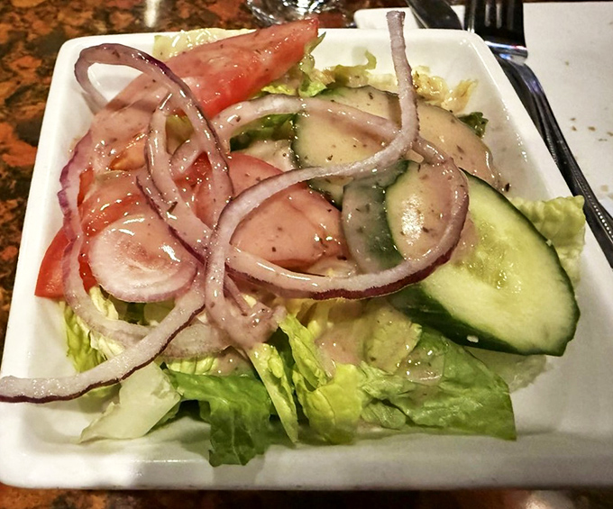 A simple house salad that knows its supporting role&mdash;crisp, fresh, and ready to balance all that glorious pasta you're about to devour.
