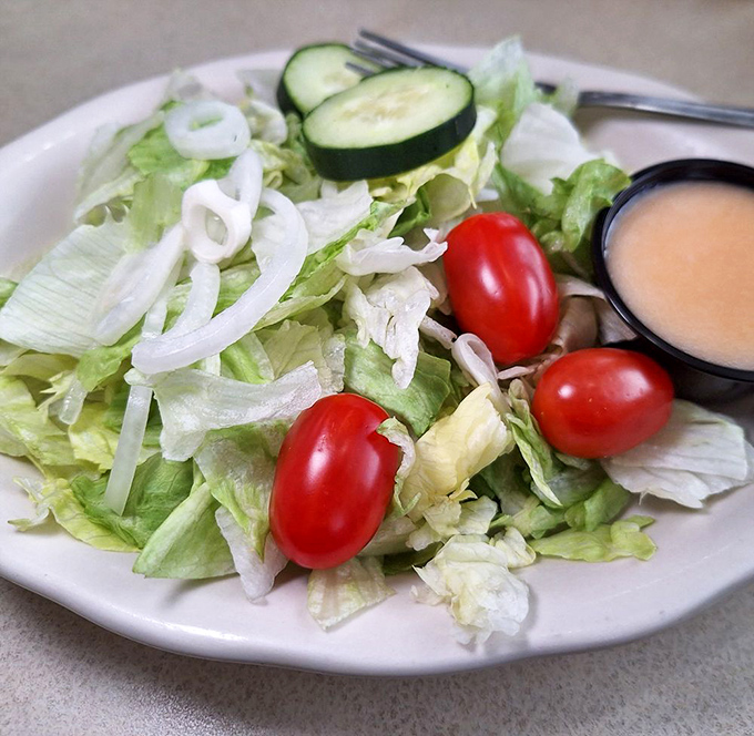 A garden-fresh side salad with crisp vegetables and house dressing&mdash;the virtuous prelude that justifies the pie finale that's surely coming. 