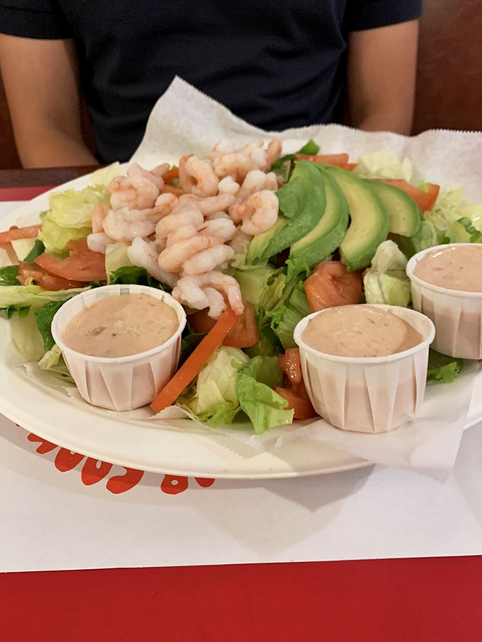 A shrimp salad that makes eating greens feel like an indulgence rather than a virtue. Those three dressing cups aren't excess &ndash; they're insurance against running out.