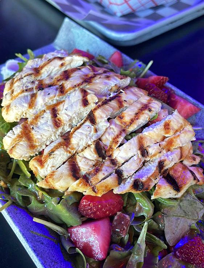 Who said salads can't be exciting? This perfectly grilled chicken atop fresh greens and berries proves healthy eating doesn't mean flavor sacrifice.
