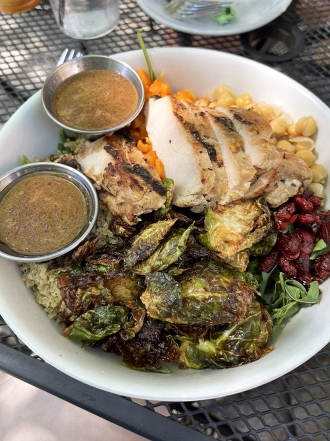 A bowl that contains multitudes—grilled chicken, crispy Brussels sprouts, and enough healthy stuff to justify ordering dessert afterward.