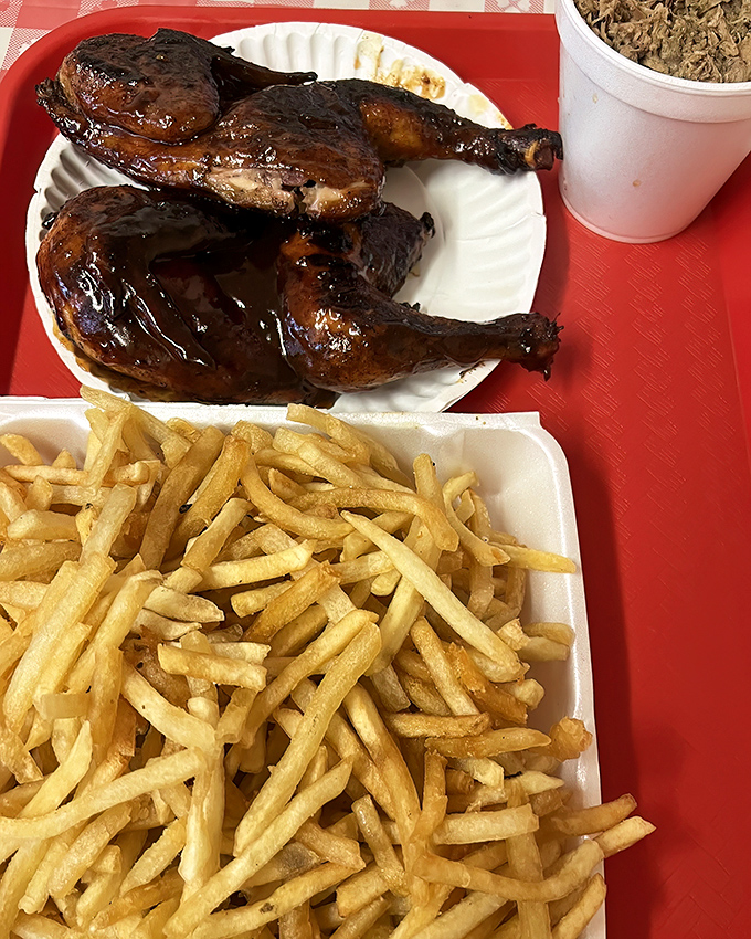 Smoked chicken with that mahogany skin is barbecue's unsung hero, especially when flanked by golden fries and a side of pulled pork.