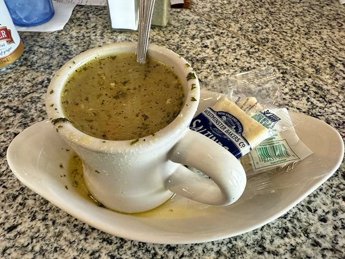 A mug of soup that warms both hands and soul. Served with crackers that are destined for a delicious dunking fate.