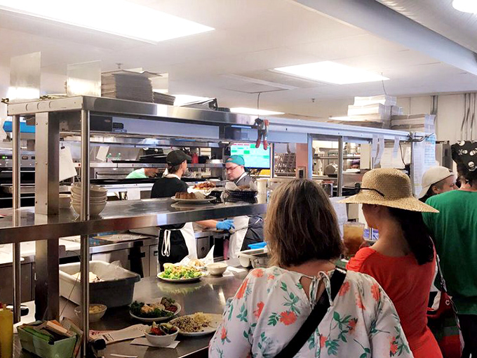 Behind the counter, sandwich artists perform their craft with the focus of brain surgeons and the creativity of jazz musicians.