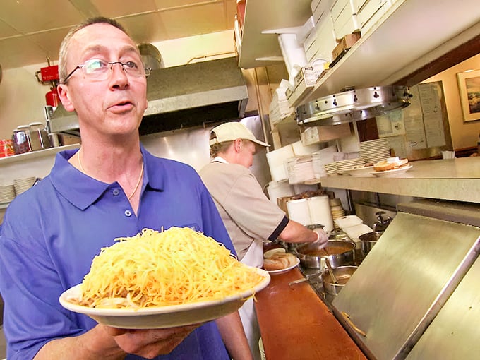 The pride of presentation is real&mdash;that mountain of cheese isn't just food, it's a work of art delivered with well-deserved confidence.