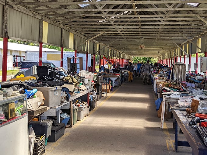 The corridor of possibility. Each stall represents a different vendor's vision, creating a patchwork of merchandise that rewards the patient explorer.