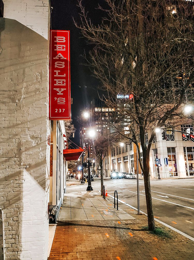 The vertical neon sign glows like a lighthouse for the hungry, guiding downtown wanderers toward crispy, honey-drizzled salvation.