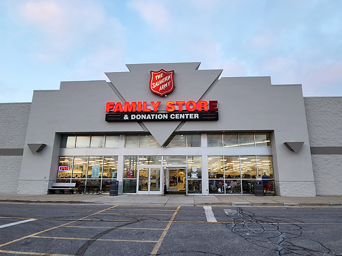 As dusk settles, the Salvation Army's glow beckons to bargain hunters. Like a lighthouse guiding ships to shores of affordable treasures.