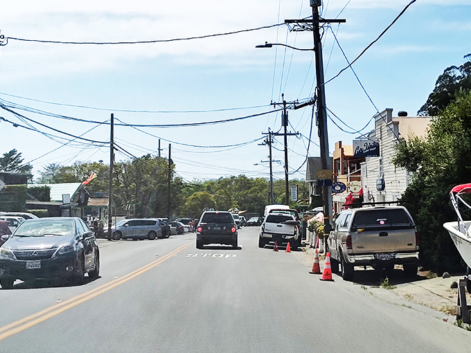 Main Street traffic jam, Stinson style: three cars waiting patiently while someone parallel parks their SUV next to a boat.