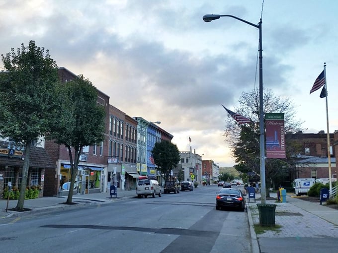As evening settles on Honesdale's Main Street, the golden hour transforms ordinary storefronts into something that belongs on a vintage postcard.