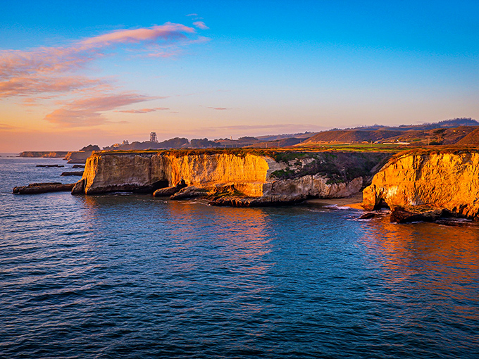 Sunset paints the coastal cliffs in honey-gold light that no Instagram filter could improve. Nature showing off at golden hour.