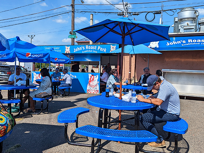 The outdoor dining experience&mdash;where blue tables under blue skies create the perfect backdrop for the serious business of sandwich enjoyment.
