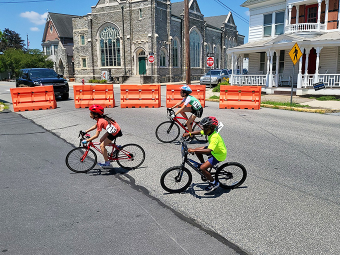 Young cyclists navigate Hummelstown's historic streets during the Criterium, proving the town nurtures both its architectural heritage and its future champions.