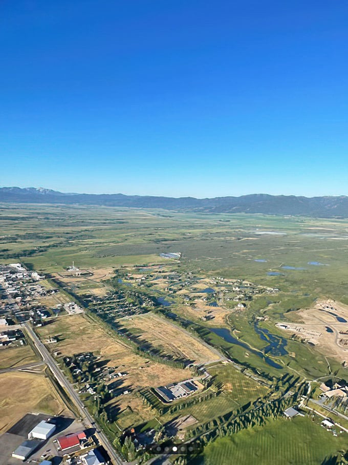 Driggs from above reveals the perfect balance of civilization and wilderness. The patchwork of farms, streams, and neighborhoods looks like nature's version of a well-planned potluck.