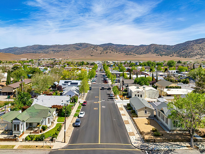 Tree-lined neighborhoods spread beneath mountain guardians, showcasing the affordable California dream that doesn't require winning the lottery.