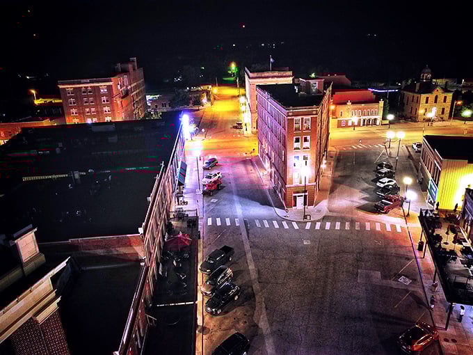 As night falls, Pawhuska's downtown glows with warm light, the Triangle Building standing sentinel at the crossroads of past and present.