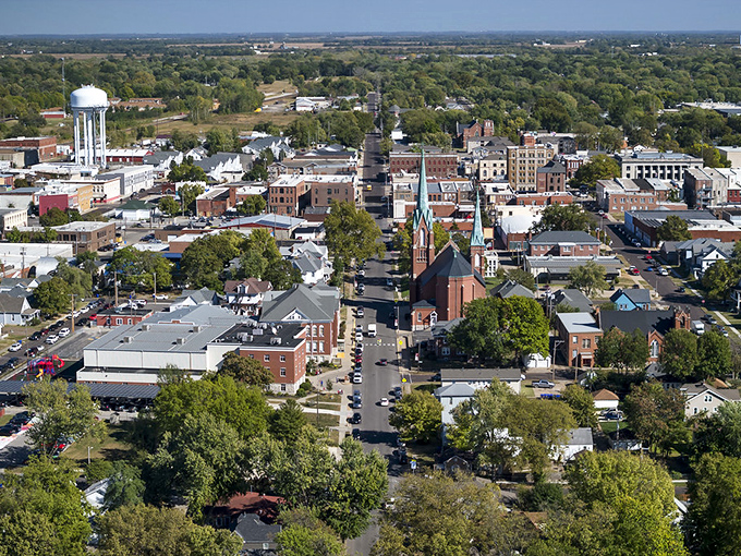 From above, Sedalia reveals itself as a perfect grid of green canopy and red brick, where small-town living unfolds at a civilized pace.