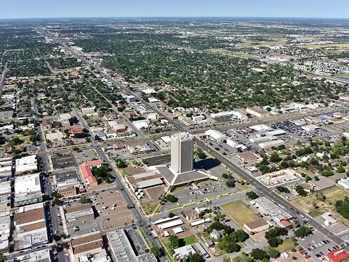 An aerial view reveals McAllen's perfect grid layout surrounded by lush greenery. From up here, retirement planning looks a lot like "find sunny spot, insert self, enjoy."