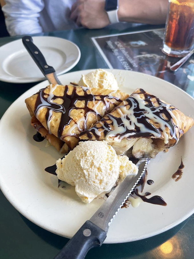 This isn't just dessert; it's a warm, cinnamon-dusted love letter drizzled with chocolate and vanilla ice cream. The sweet finale to a seafood symphony.