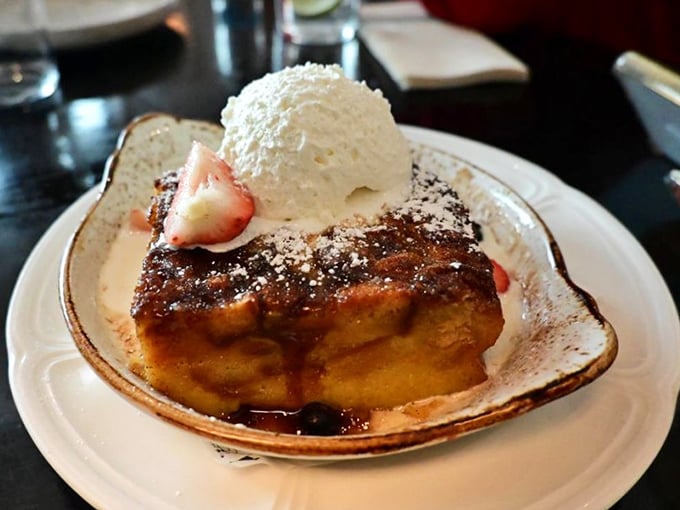 Bread pudding that transcends its humble origins, topped with a scoop of ice cream melting into warm, cinnamon-spiced perfection.