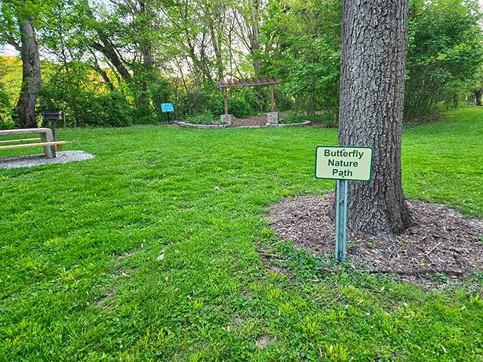 Follow the flutter. This unassuming sign points to one of the park's hidden treasures&mdash;a pathway where butterflies transform an ordinary walk into magic.