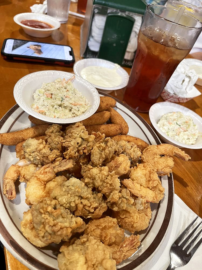 Butterfly shrimp and fried oysters sharing a plate like old friends. The coleslaw mediates this delicious meeting with creamy, tangy diplomacy.
