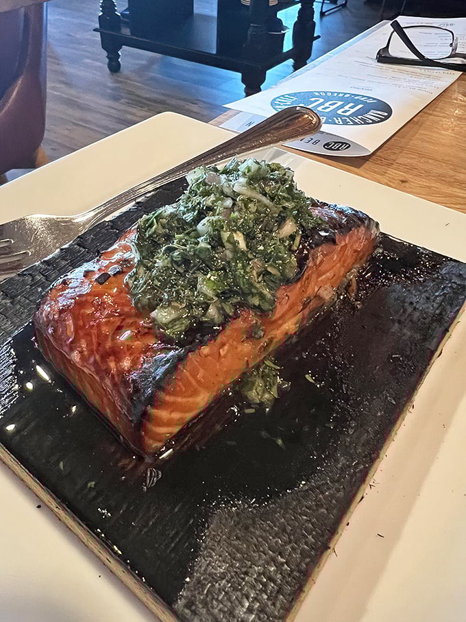 Cedar plank salmon topped with fresh herbs, proving this kitchen handles seafood with equal finesse and care.