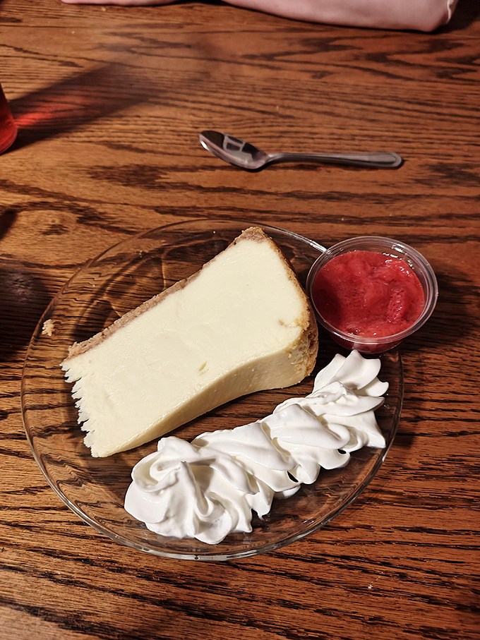 New York cheesecake with berry compote and whipped cream&mdash;because after conquering a steak, you deserve a victory dessert.