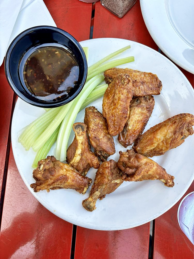 These wings aren't playing second fiddle to burgers&mdash;they're conducting their own spicy symphony with crispy skin and tender meat that falls off the bone.