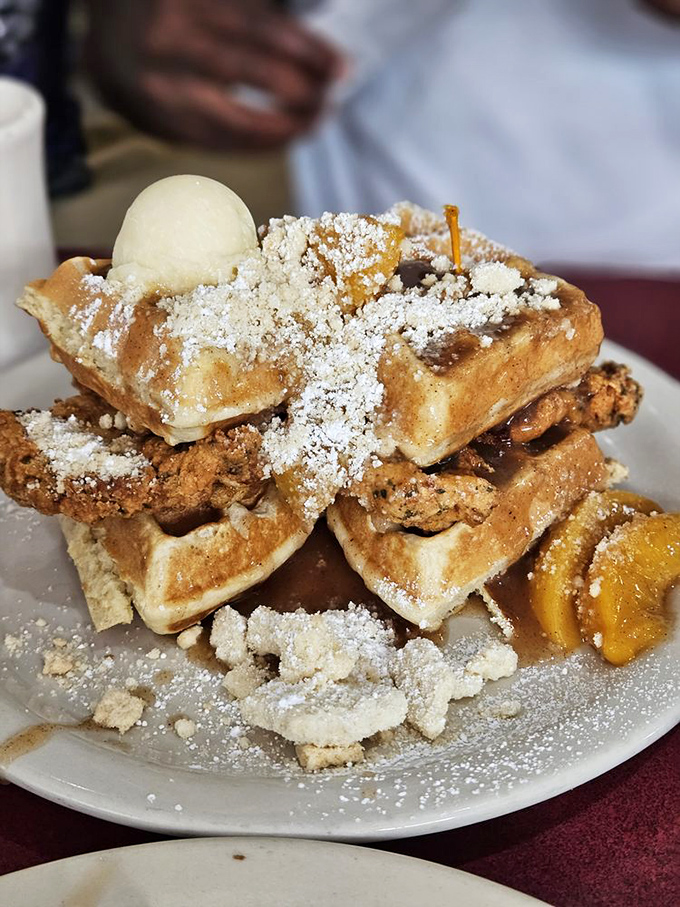 A powdered sugar snow falls on golden waffles and crispy chicken. The kind of breakfast that makes you want to hug the chef.