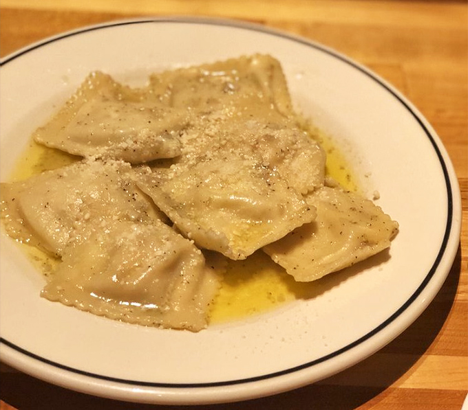 Ravioli bathed in butter and dusted with parmesan – proof that sometimes the simplest preparations create the most profound flavors.
