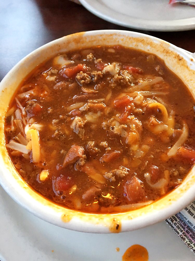 A bowl of homemade chili that looks like it's been simmering since yesterday, because proper diner chili needs time to tell its story.