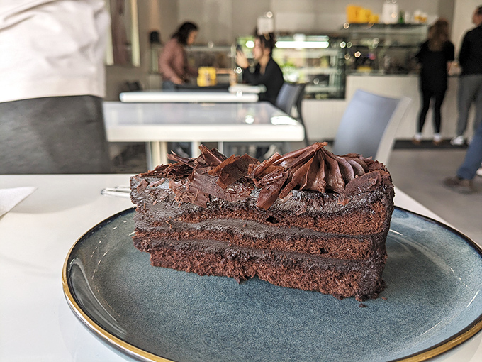 This chocolate cake looks like it's auditioning for a starring role in your dessert fantasies&mdash;three layers of intensity that demand to be savored slowly.