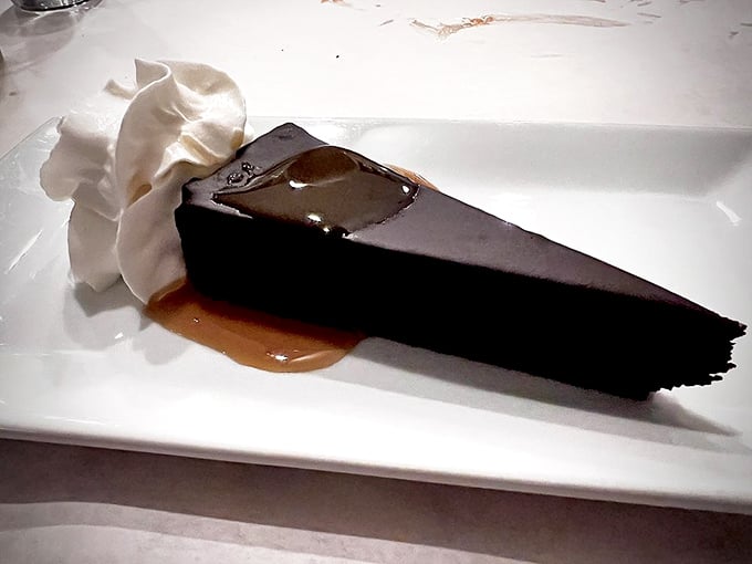 Chocolate cake so dark and rich it should come with its own warning label. That caramel drizzle isn't decoration—it's the final perfect note in a symphony.