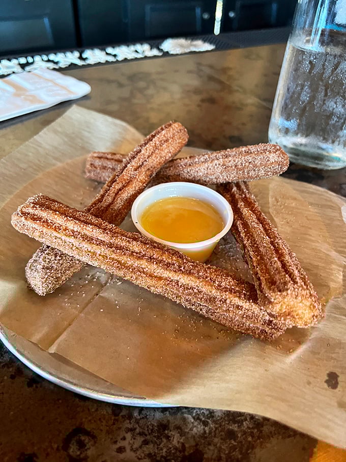 Churros that crackle with cinnamon-sugar promise, served with a dipping sauce that makes you wonder why you'd ever waste calories on lesser desserts.