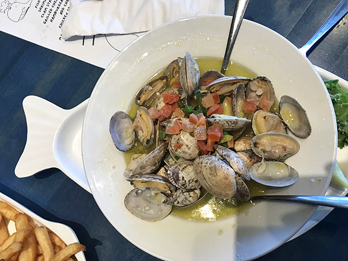 Steamed clams swimming in garlicky broth with fresh tomatoes&mdash;proof that sometimes the simplest preparations deliver the most profound seafood joy.
