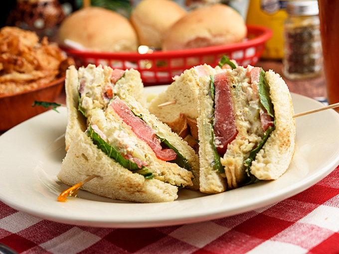 The club sandwich &ndash; architectural marvel of bread, meat, and vegetables &ndash; stacked tall enough to require a strategic approach to that first bite.