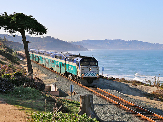 The Coaster train hugs the Del Mar coastline so perfectly it feels like a movie set designer placed it there just for your vacation photos.