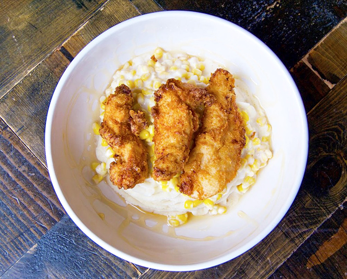 Crispy chicken nestled on a cloud of mashed potatoes &ndash; comfort food that bridges cultures and reminds us why simple pleasures often taste the best.