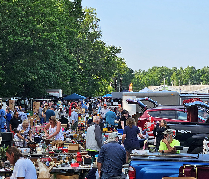 The outdoor market transforms into a bustling village of discovery, where strangers united by the thrill of the hunt become temporary neighbors.