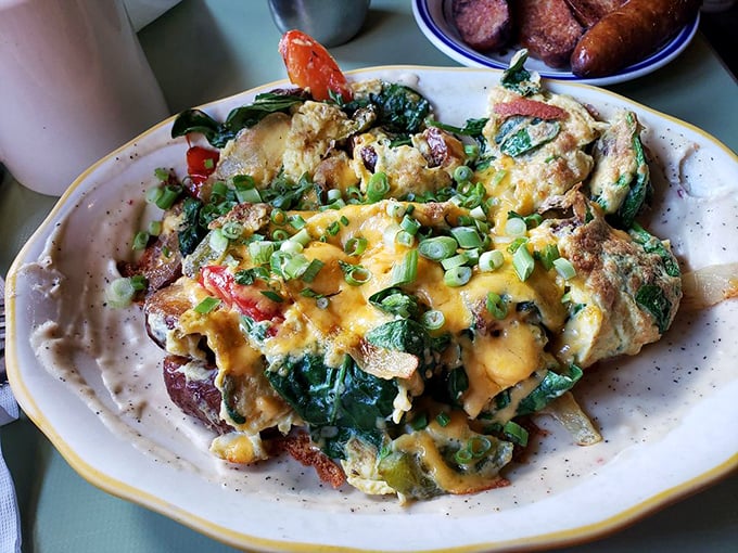 An omelet that's having an identity crisis as a colorful work of art. Those vibrant vegetables and melted cheese create a breakfast masterpiece.