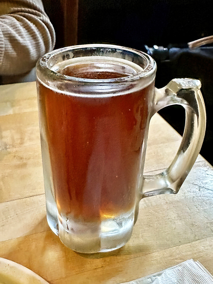 A proper pint that catches the light like amber treasure. Beer as it should be&mdash;cold, unfussy, and ready to wash down burger perfection.